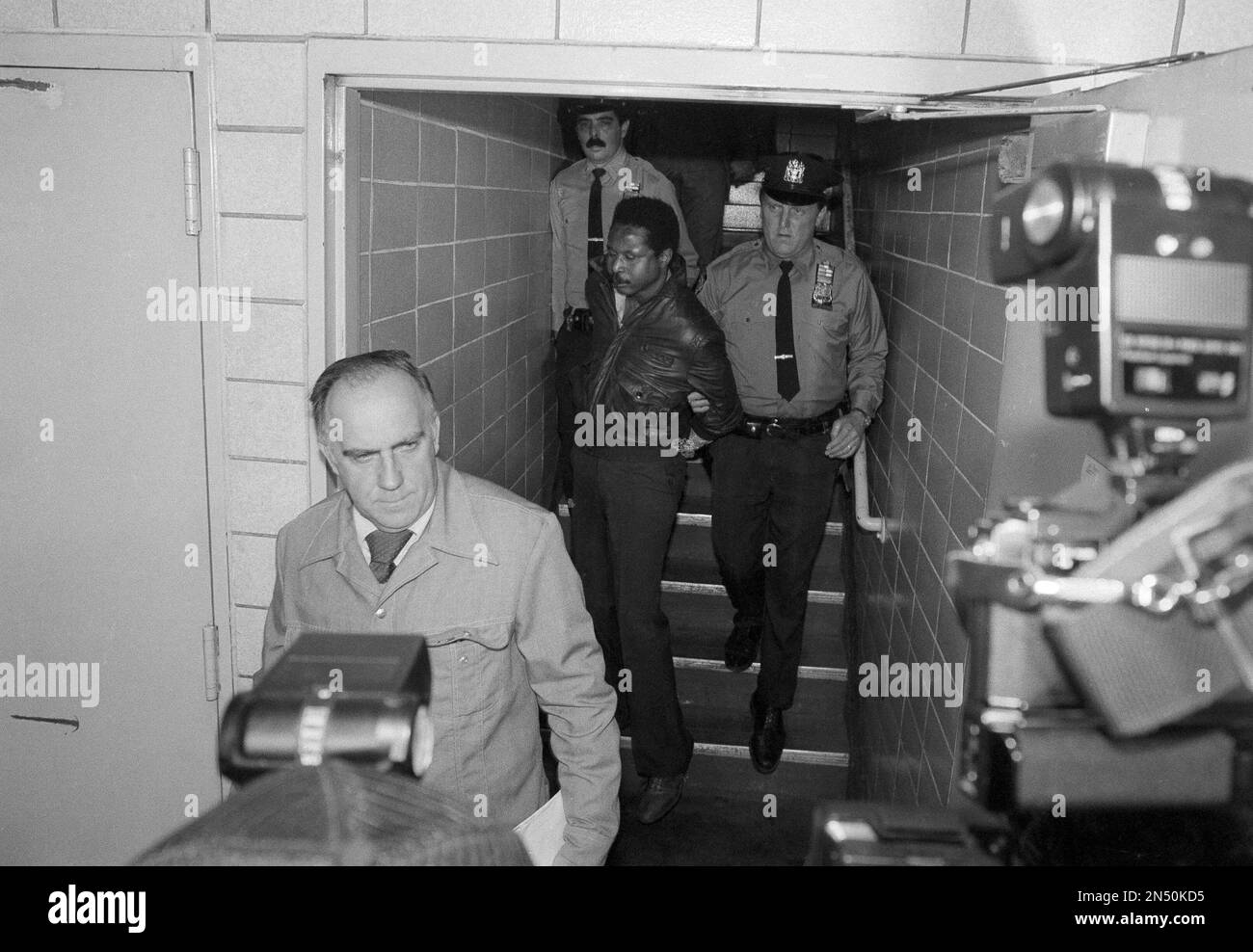 Police lead Nat Burns, also known as Nathaniel Williams, into the 112th ...