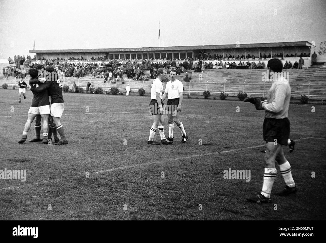Three Hungarian players embrace, left, after Florian Albert had scored ...