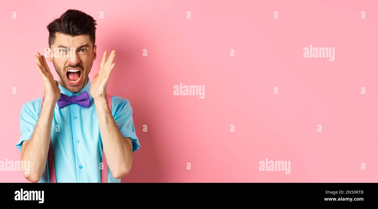 Angry man screaming like crazy, shaking hands and stare furious at ...