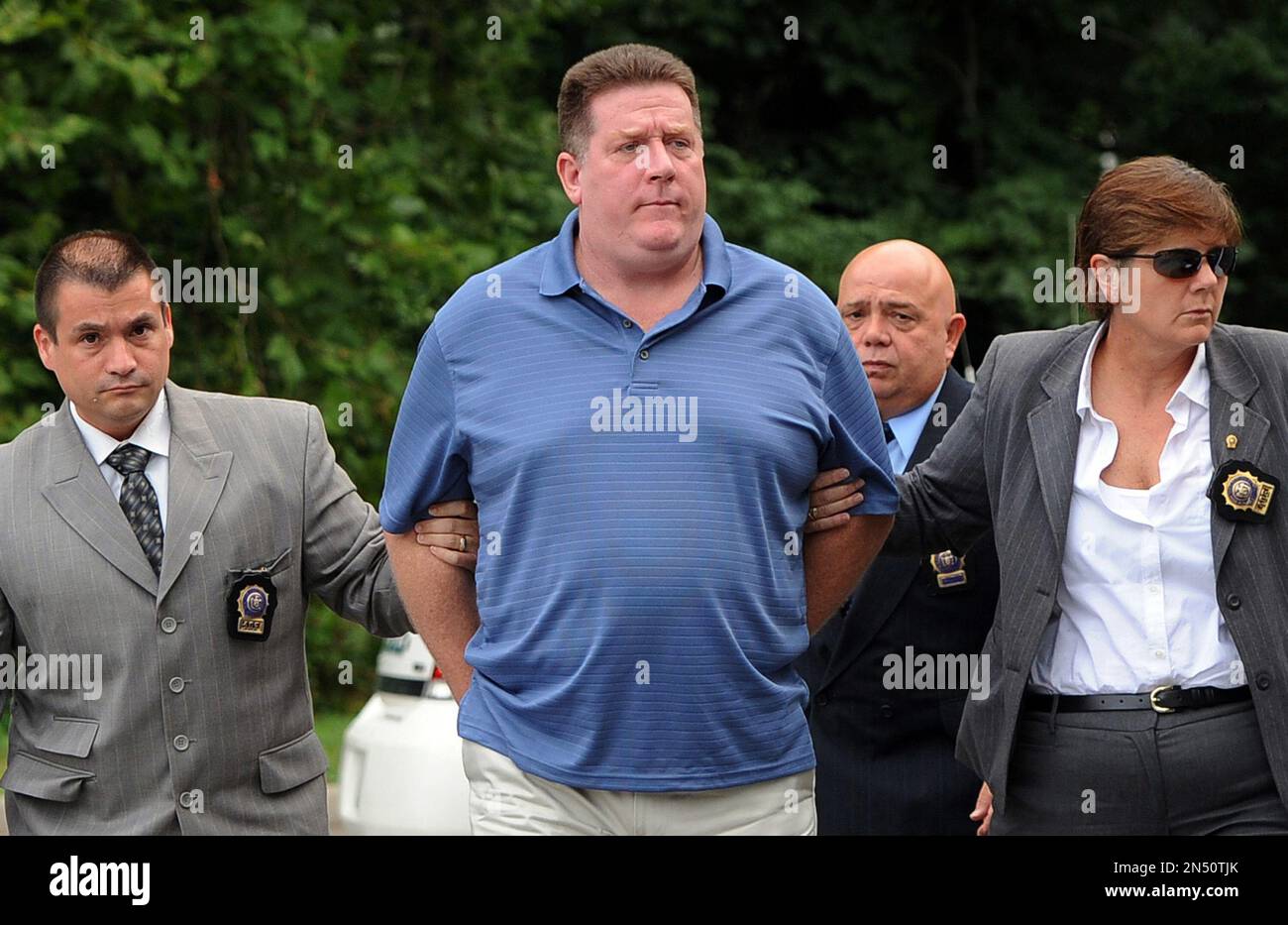 FILE - This Aug. 15, 2012 photo shows Raymond Roth, center, as he is ...