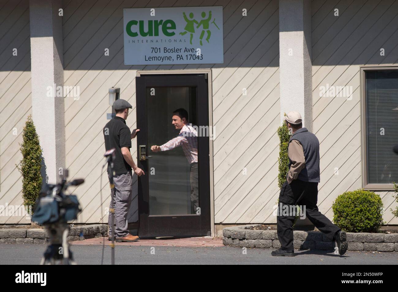 A man lets people in at the Cure International company headquarters ...