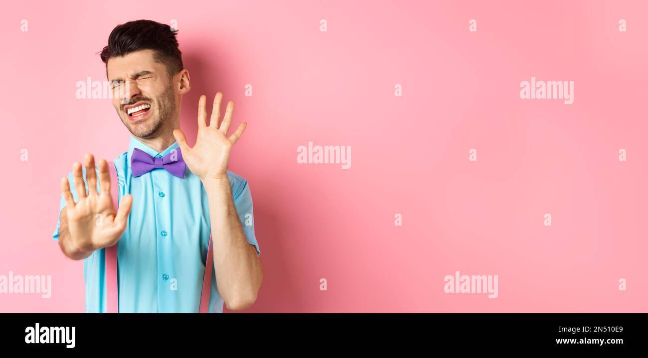 Crying guy asking to stop, raising hands up in defense, protecting ...