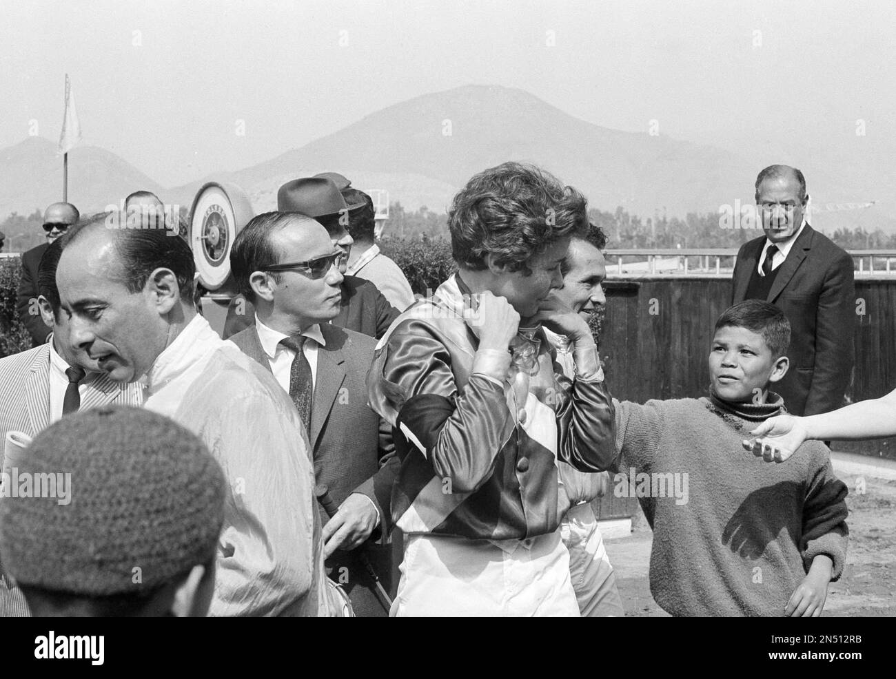 American jockey, Kathy Kusner is greeted by a young Peruvian fan after ...