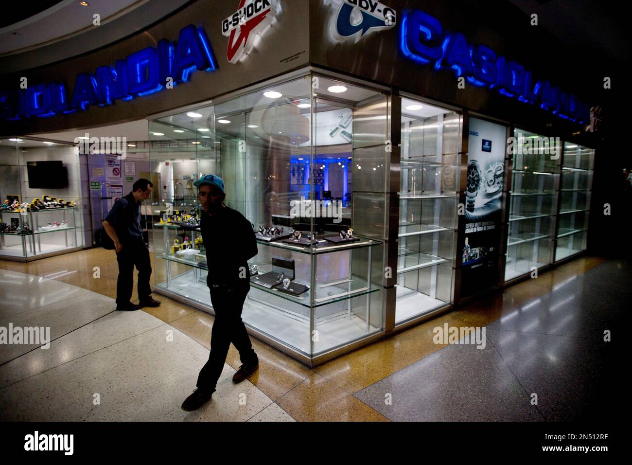 In this April 10, 2014 photo, customers walks past a Casio shop with ...