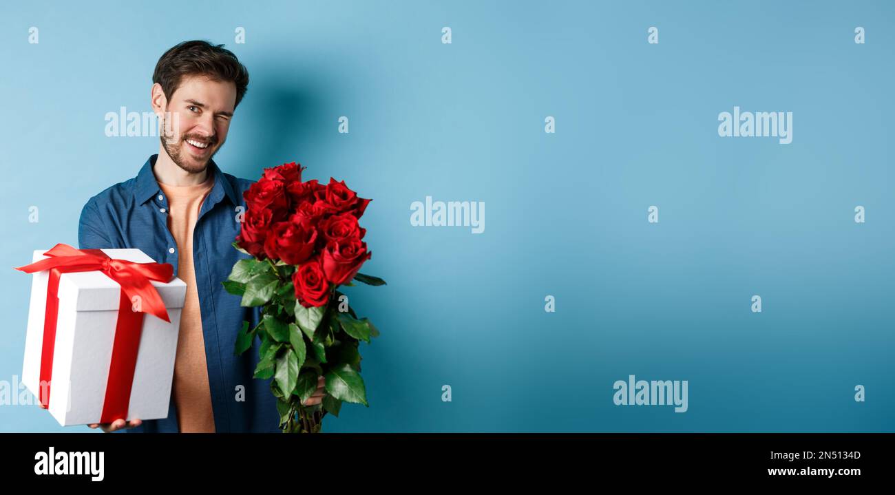 Love and Valentines day concept. Happy guy winking and smiling at ...