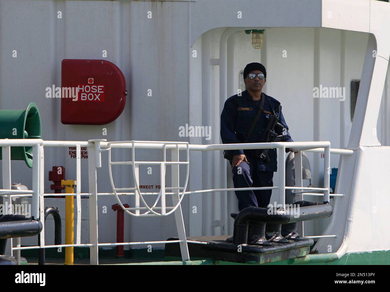 A Malaysian marine police officer stands guard on the Naniwa Maru 1 at ...
