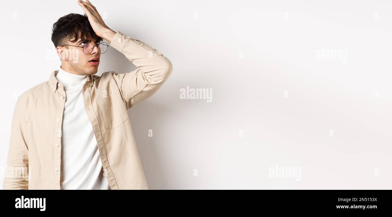 Portrait of annoyed stylish guy facepalm, roll eyes from something ...