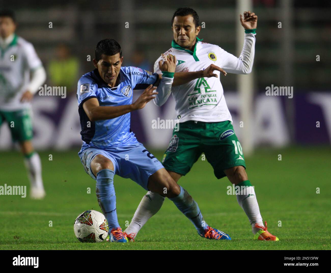 Luis Montes of Mexico's Leon, right, fights for the ball with Damir ...