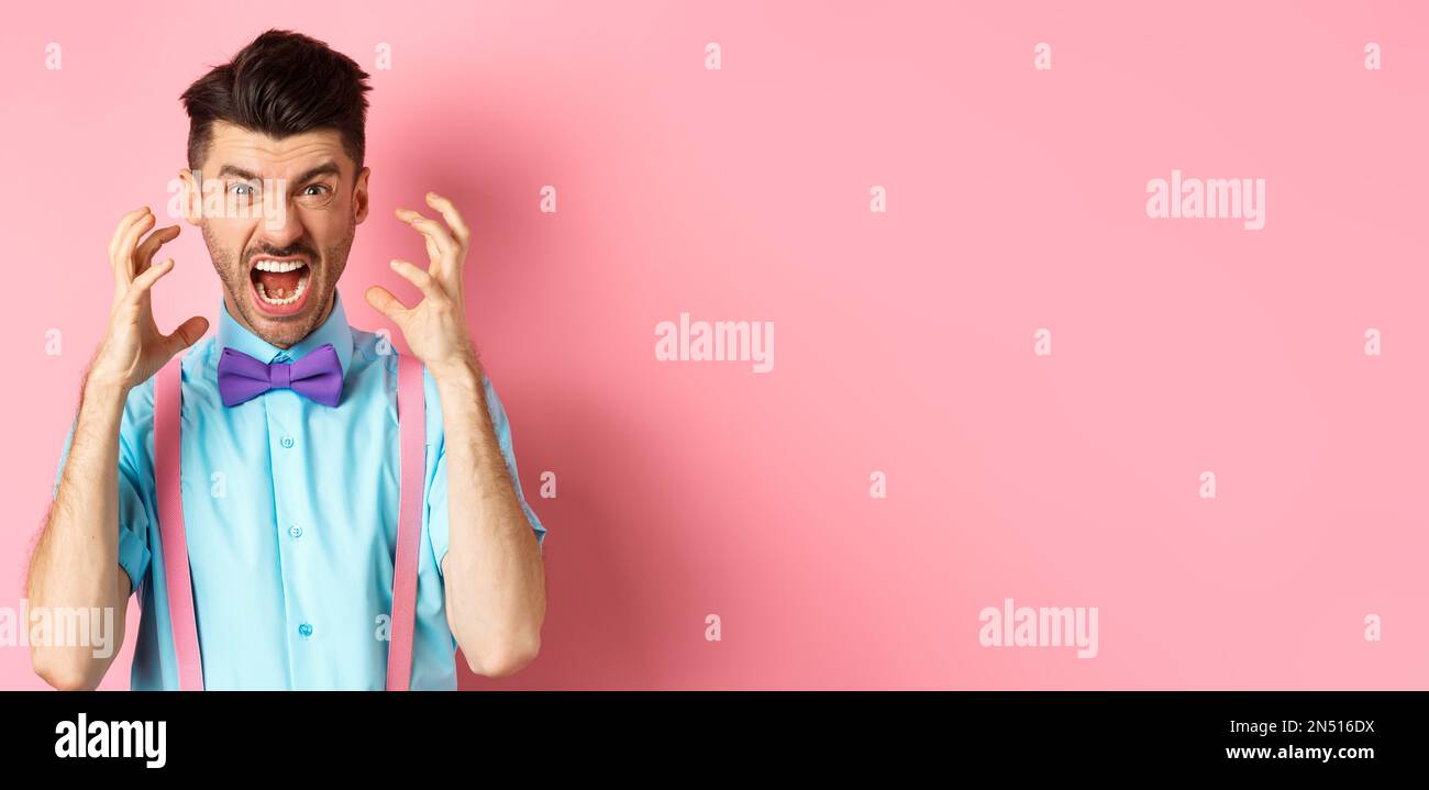 Frustrated young man losing temper, screaming and looking angry at ...