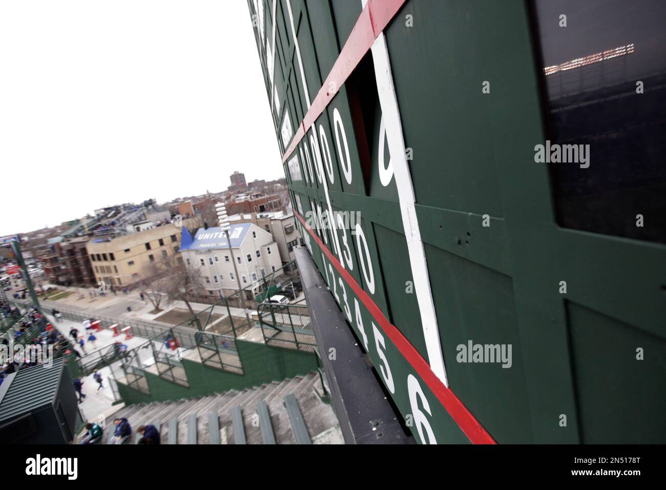 In this April 10, 2014 photo, scoreboard operator Brian Helmus changes ...