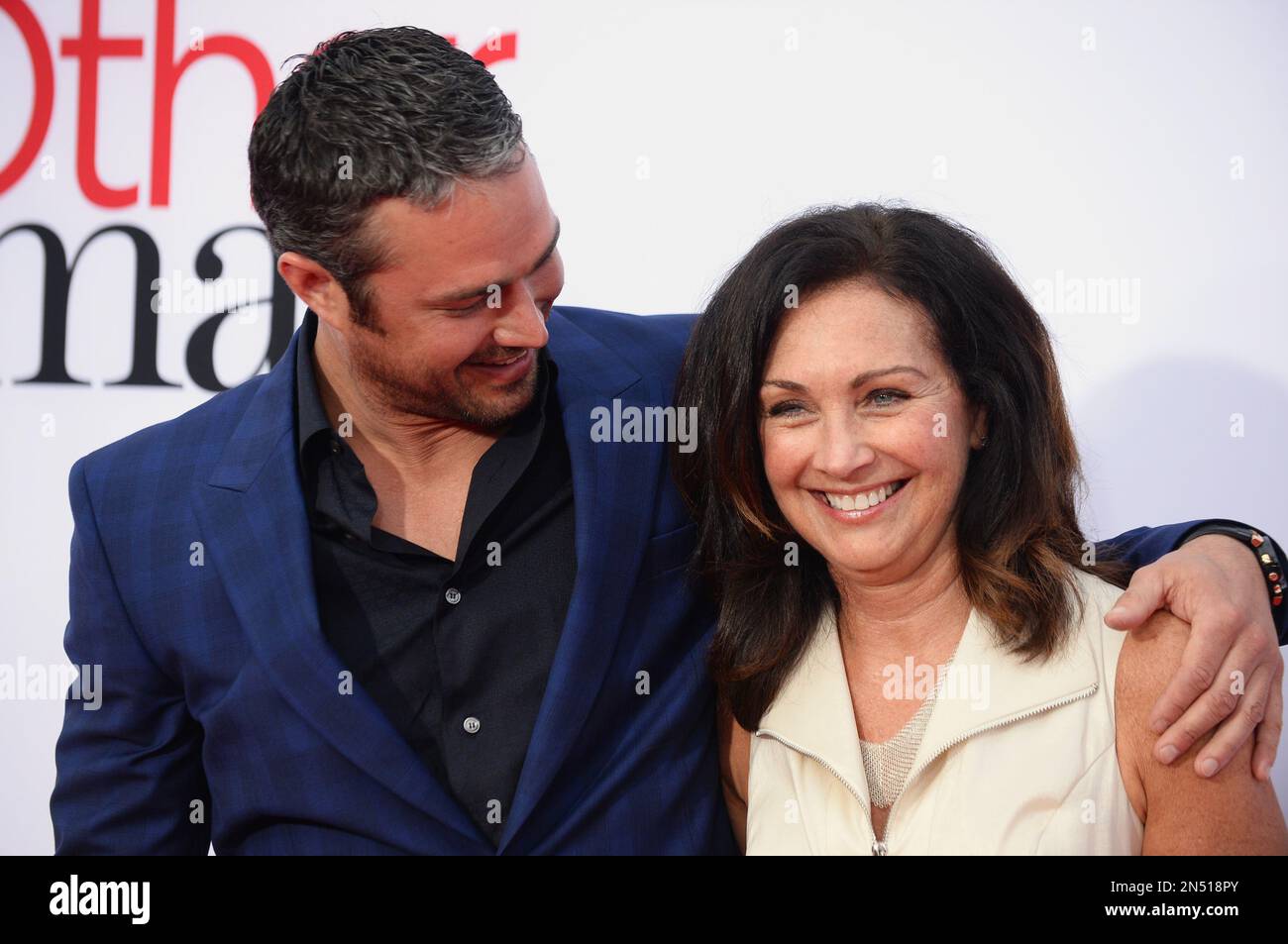 Taylor Kinney, left, and Pamela Heisler arrive at the Los Angeles ...