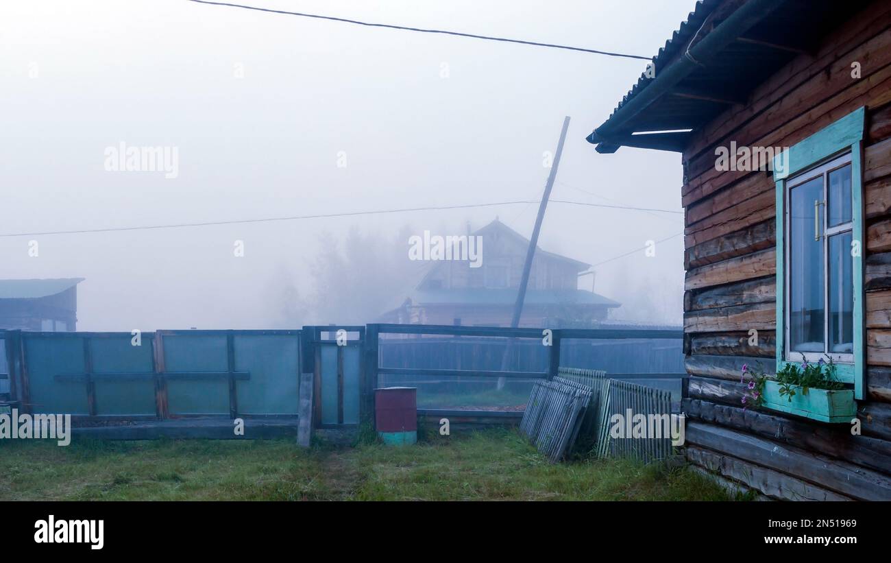 The residential area behind the fence at the edge of a wooden house ...