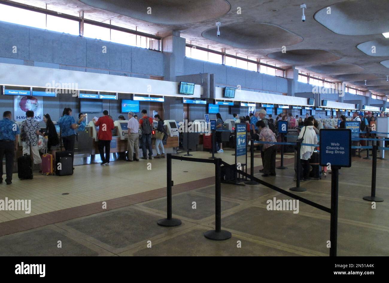 Passengers check in at Hawaiian Airlines service desks in Kahului ...