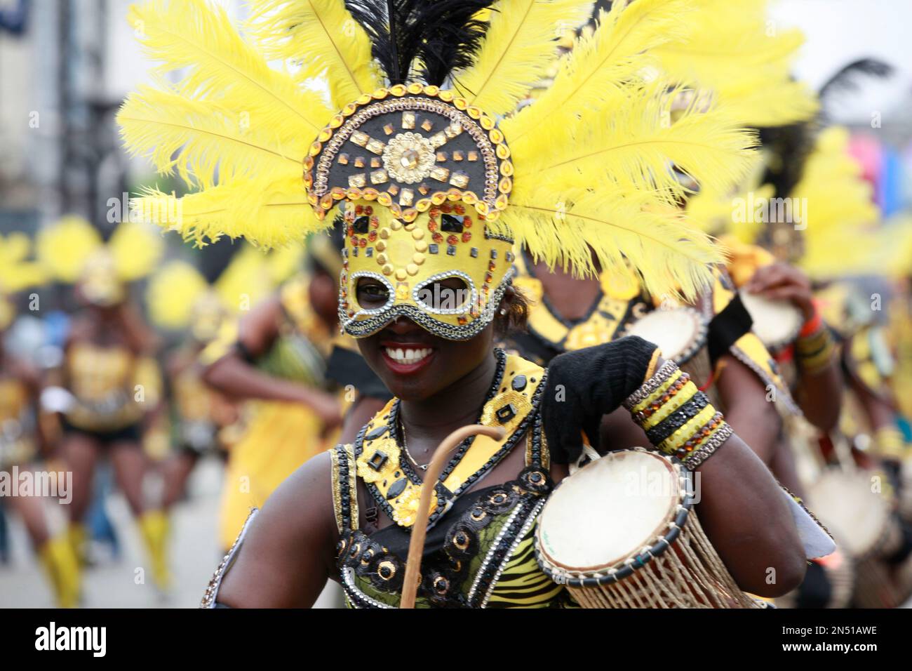 A performer dances through the street during the Lagos Carnival ...