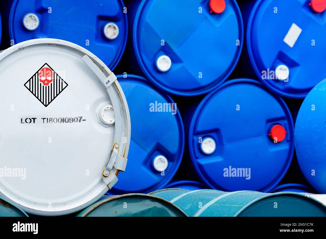 Old chemical barrels. Blue and green oil drum. Steel and plastic oil ...