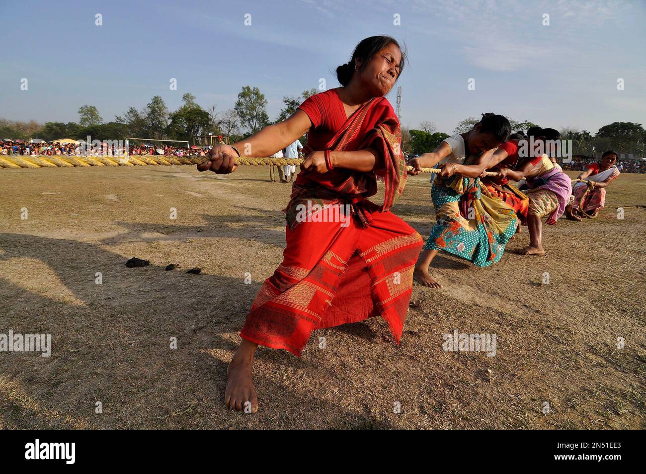 Indigenous Rabha women pull a rope as they participate in a traditional ...