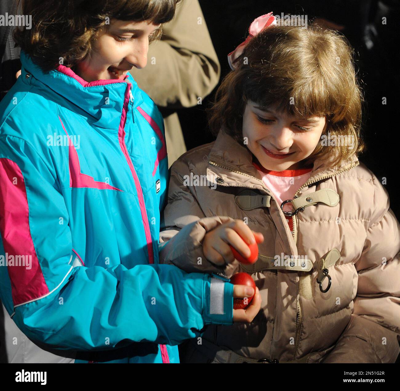 Girls break Easter eggs after Easter service at St. Clement Christian ...