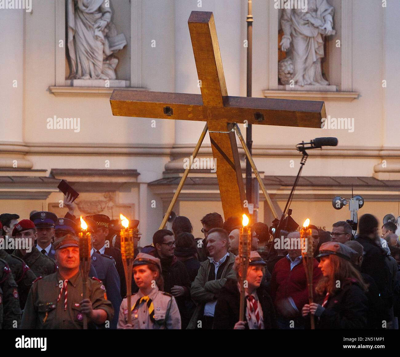 Believers hold a Cross during a Way of the Cross procession in downtown ...