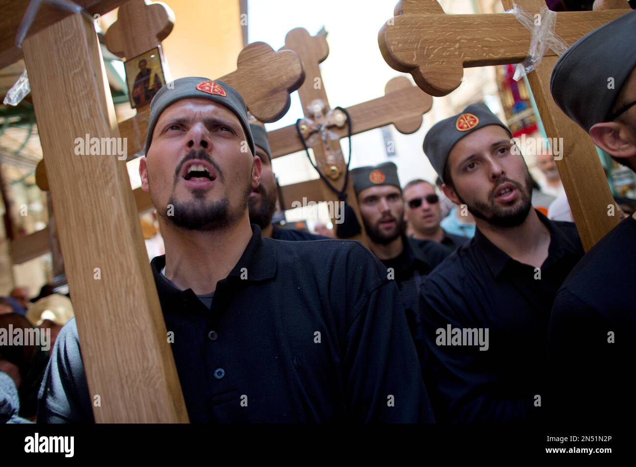 Serbian pilgrims carry crosses during Good Friday in Jerusalem Friday ...