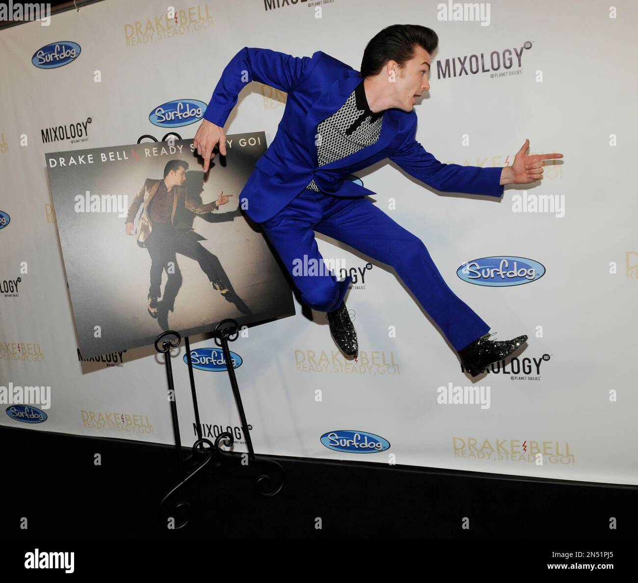 Drake Bell leaps in the air for photographers at a release party for ...