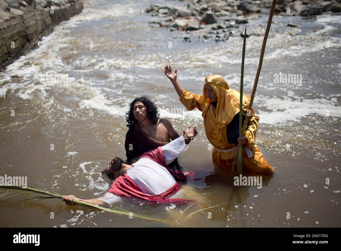 Actors reenact the baptism of Jesus during Holy Week celebrations in ...