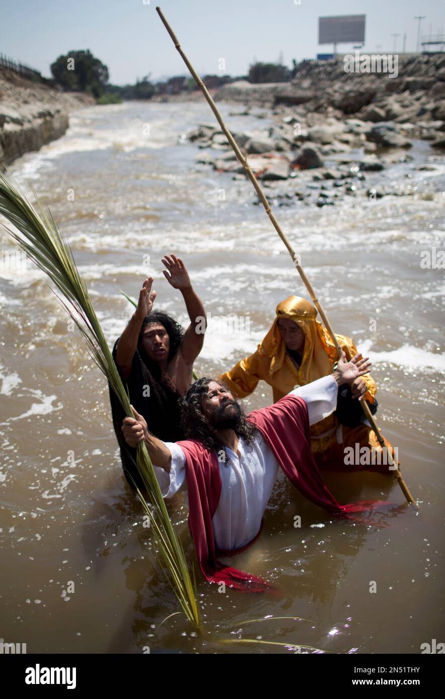 Actors reenact the baptism of Jesus during Holy Week celebrations in ...