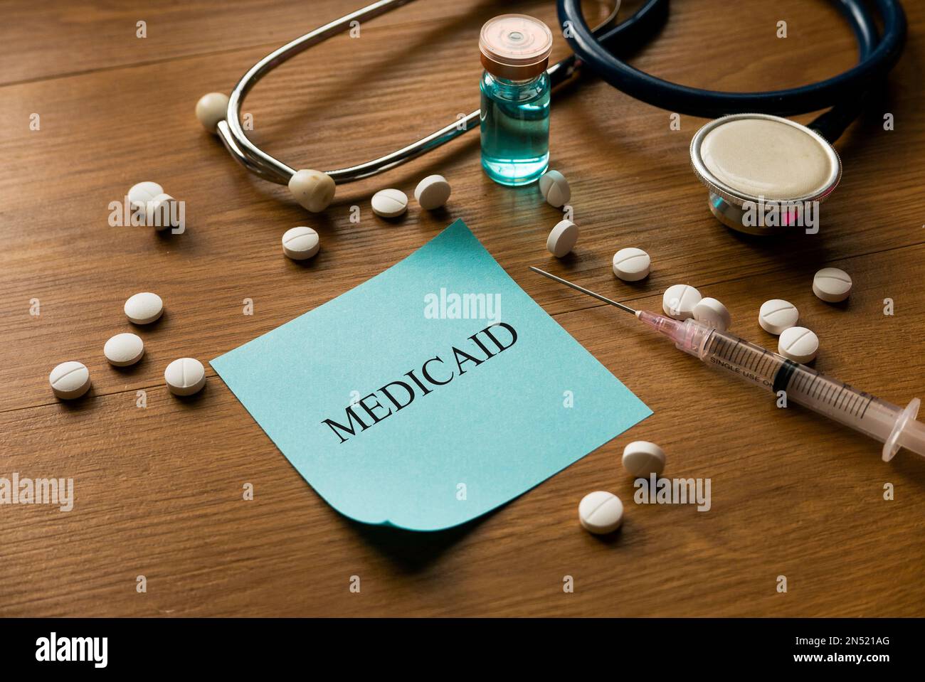 Selective focus of stethoscope, white medical pills, syringe and blue ...