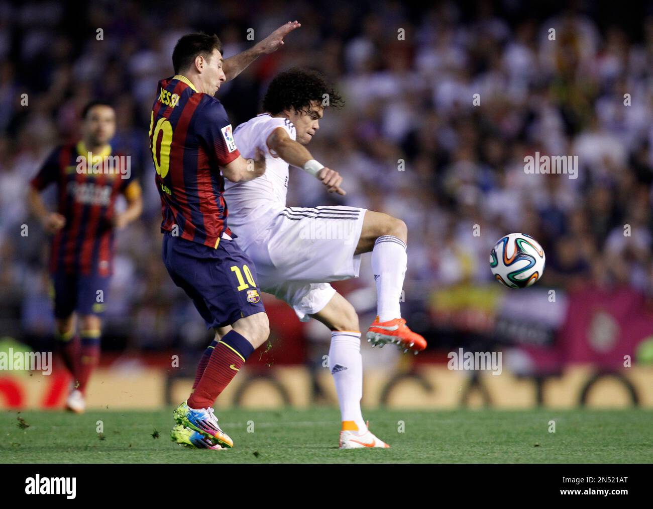 Real's Pepe, right shields the ball from Barcelona's Lionel Messi ...