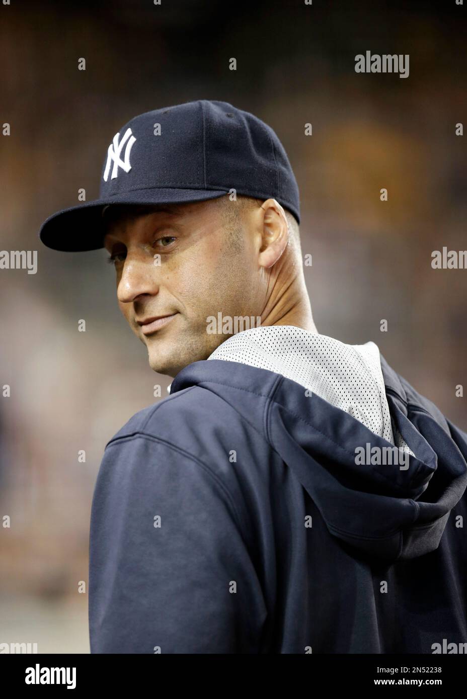 New York Yankees shortstop Derek Jeter looks toward a teammate as he ...
