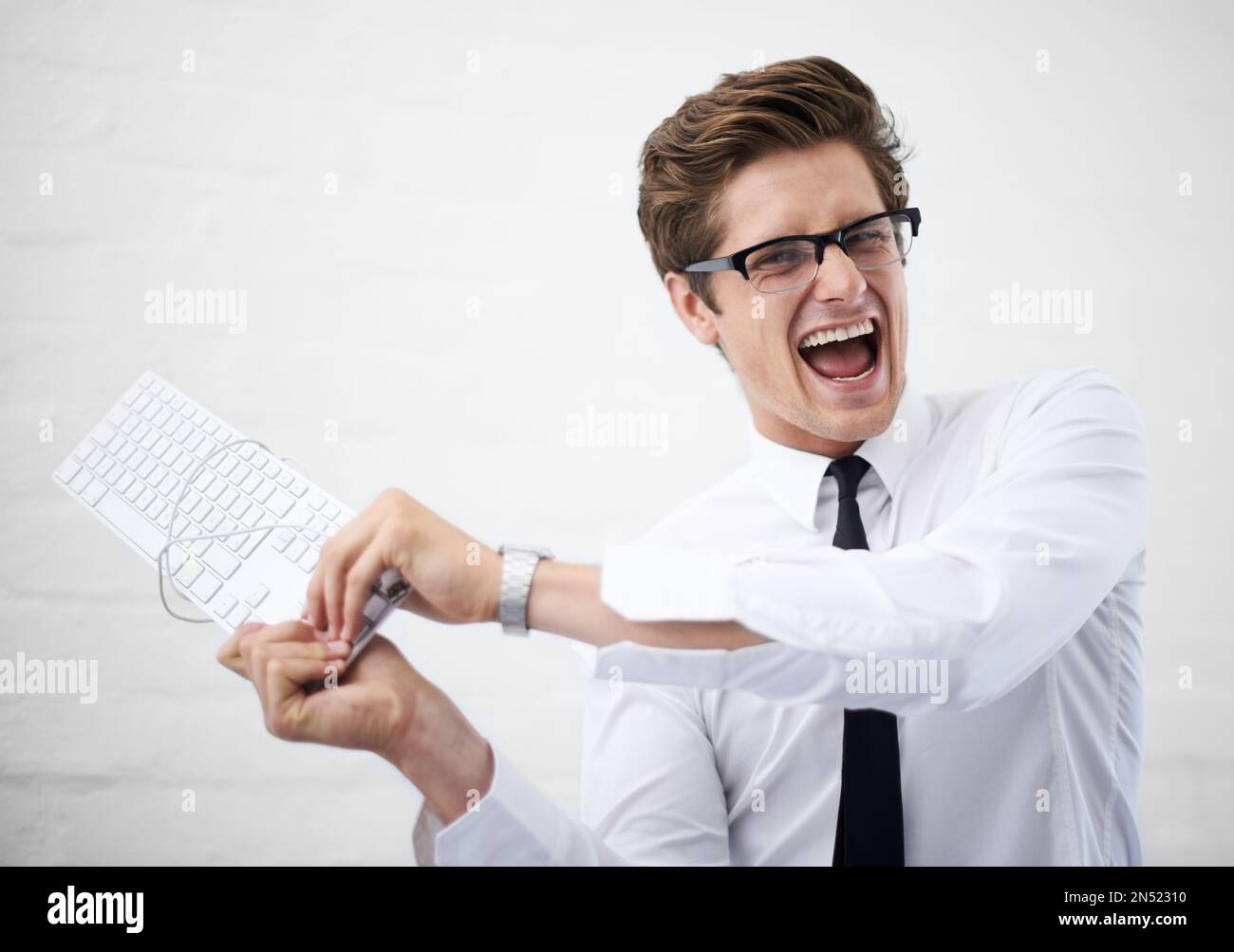 Getting rid of the old keyboard. An angry nerdy guy ready to hit ...