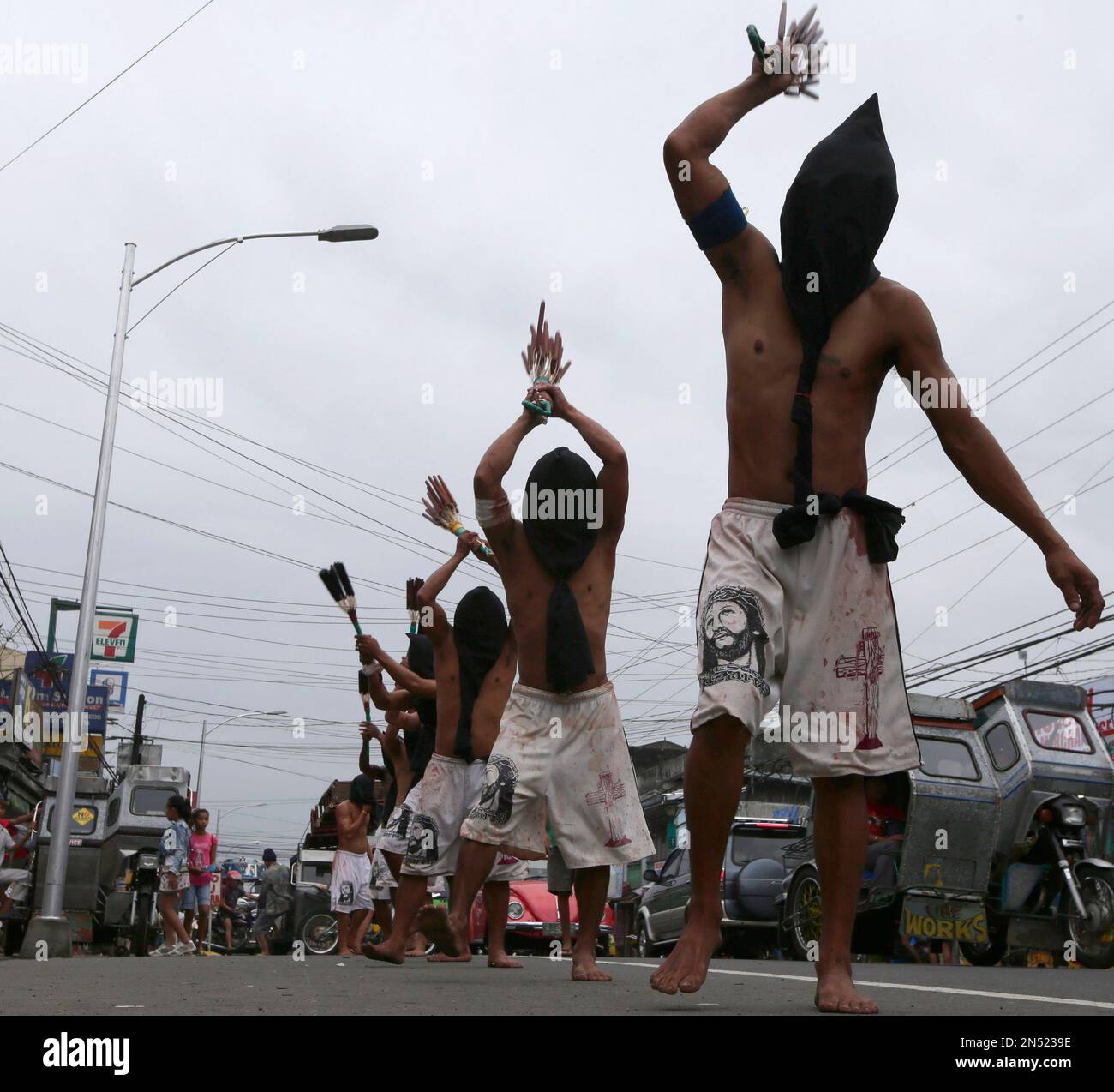 Hooded penitents flagellate themselves in a ritual to atone for their ...