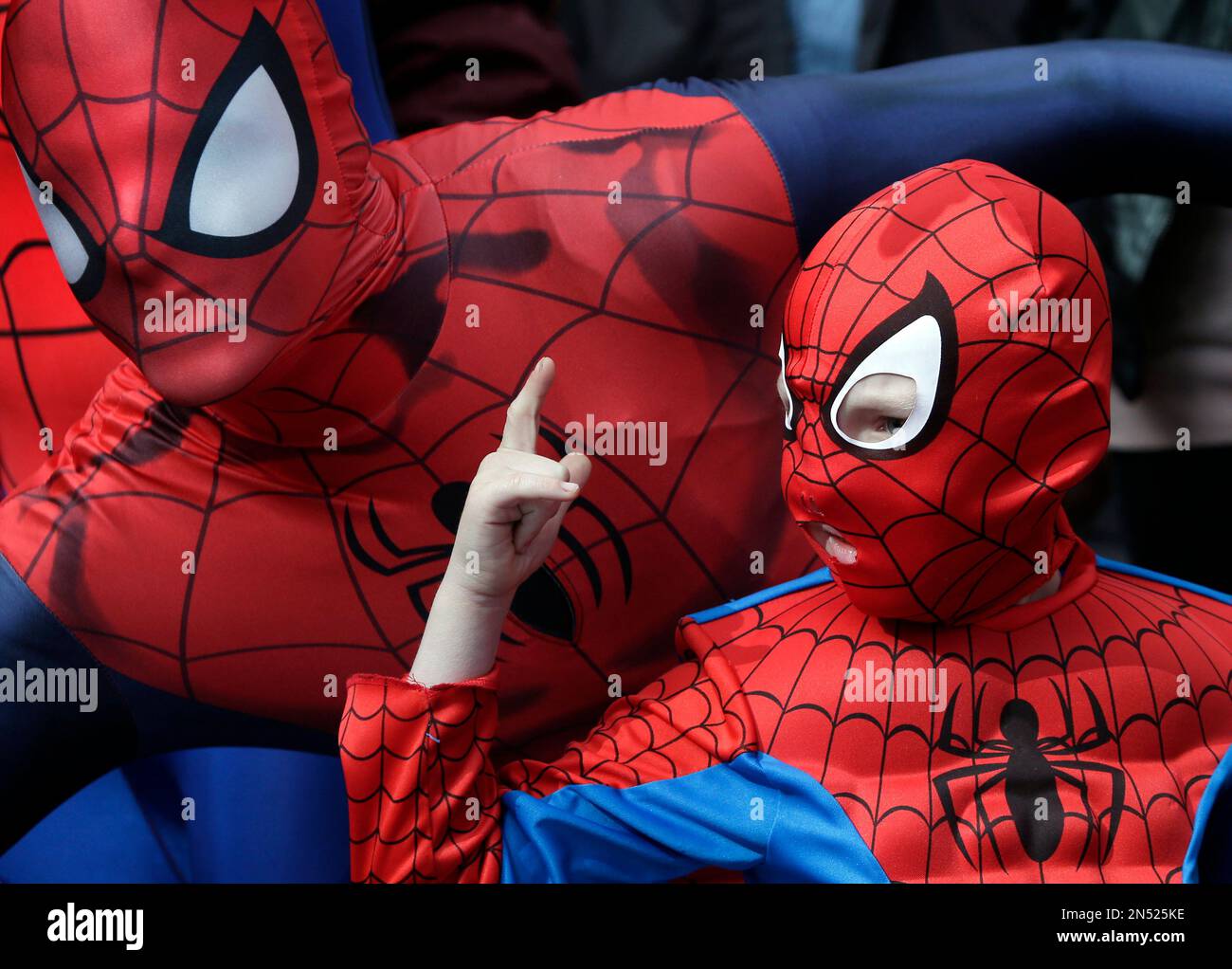 Six years old Justin, right, poses with a person dressed as Spider-Man ...