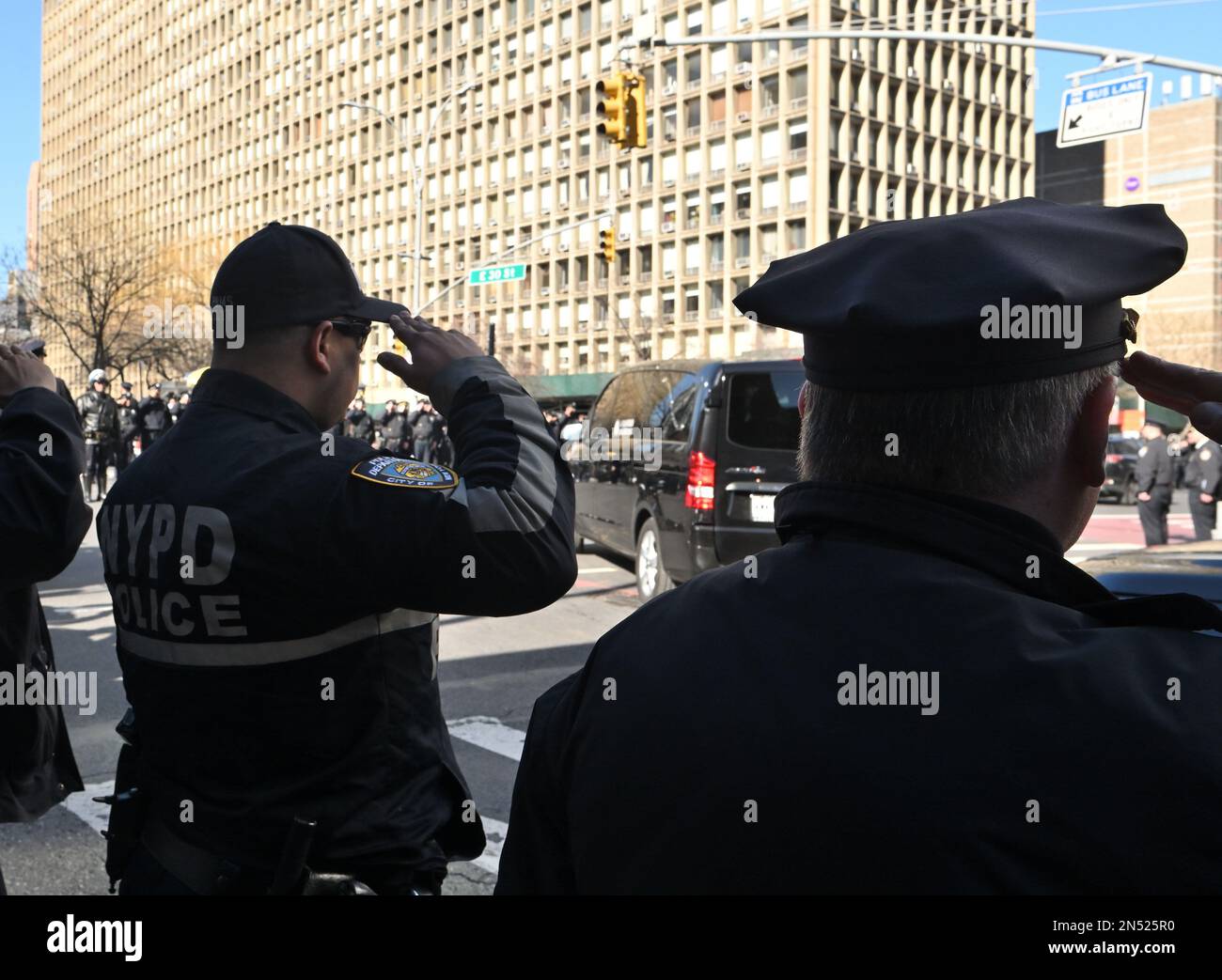 New York, New York, USA. 8th Feb, 2023. Police officers salute as body ...