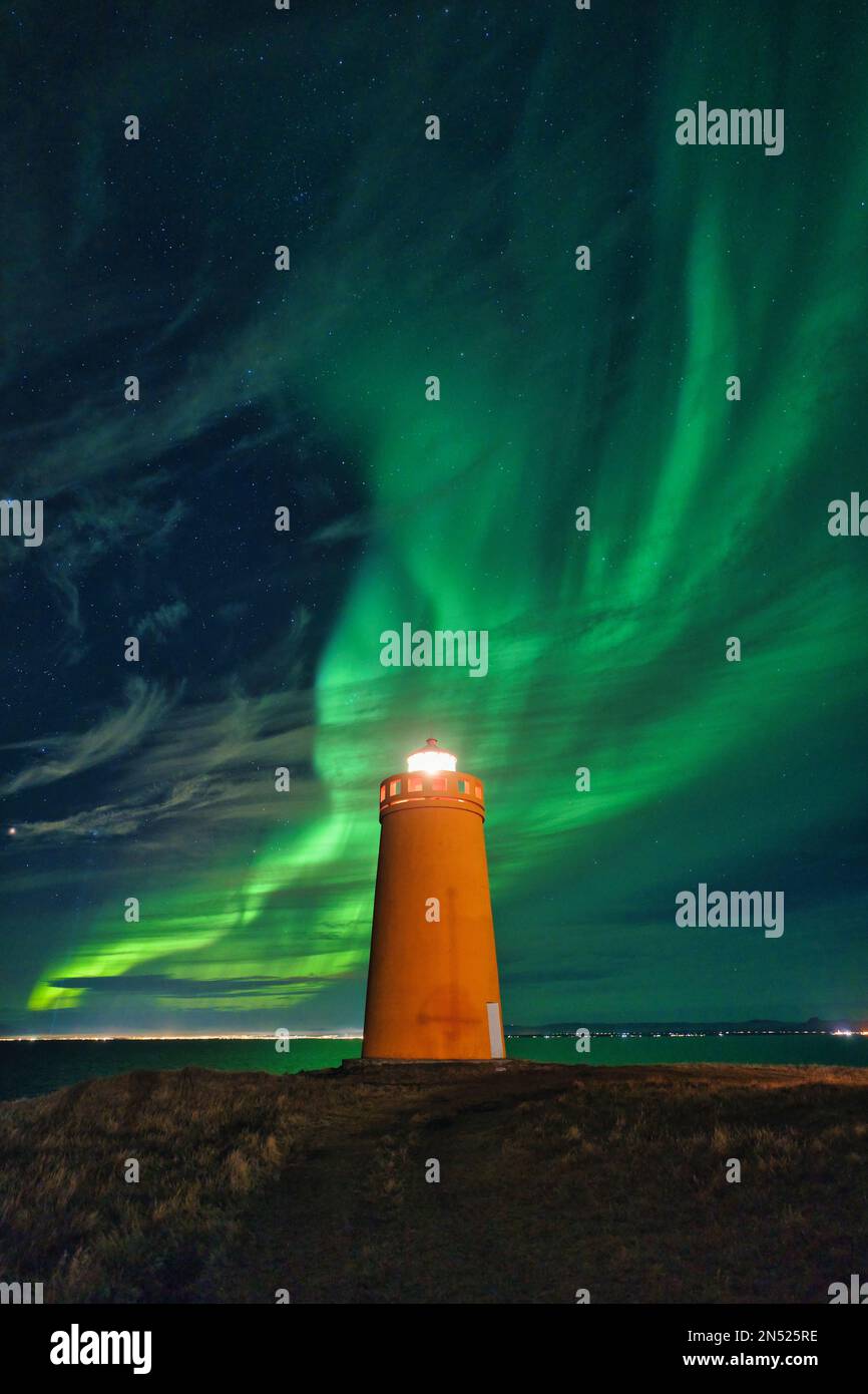A northern lights aurora borealis over lighthouse in Iceland Stock ...