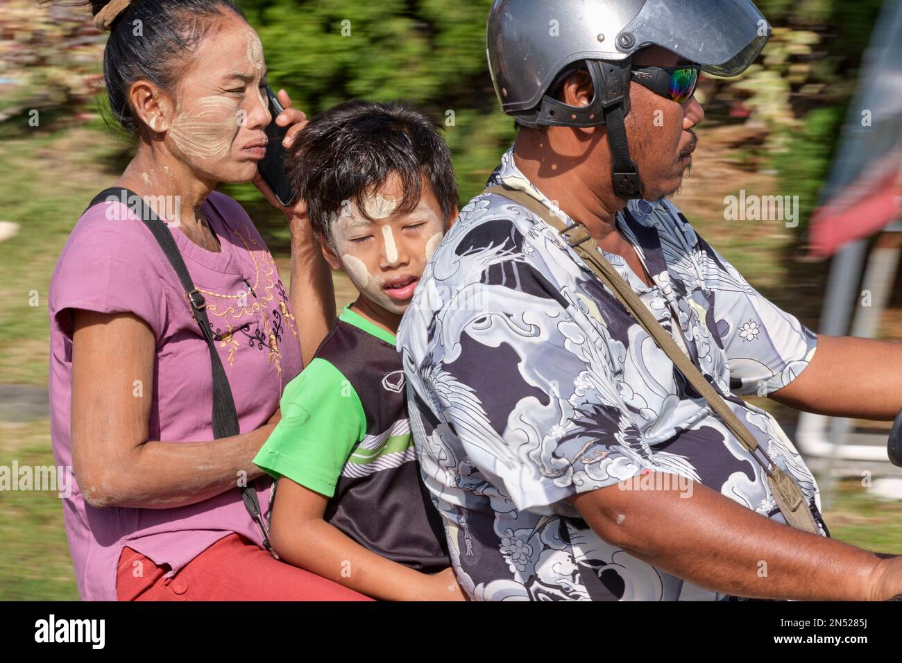 Members of a Myanmarese (Burmese) migrant family, father, mother and ...