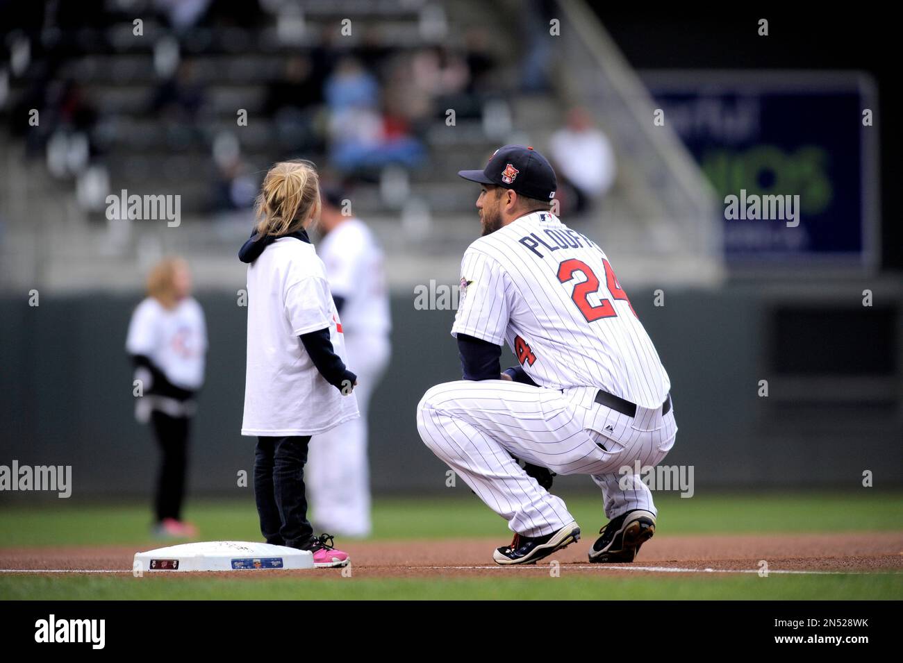 Minnesota Twins’ Trevor Plouffe talks with a little girl at third base ...