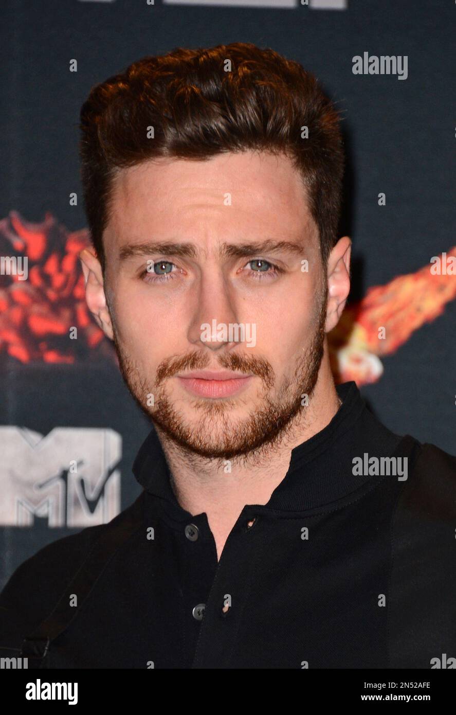 Aaron Taylor-Johnson poses in the press room at the MTV Movie Awards on ...