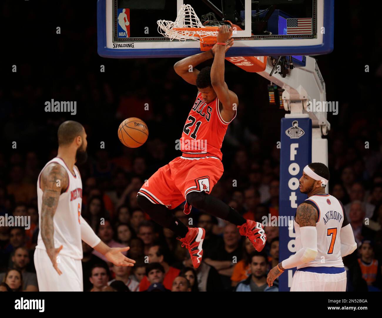 Chicago Bulls' Jimmy Butler dunks the ball while New York Knicks' Tyson ...