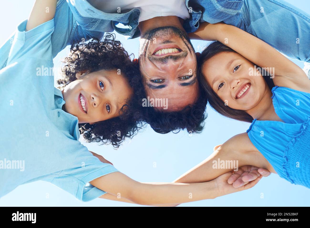 Theyre a loving young family. Low angle portrait of a family standing ...