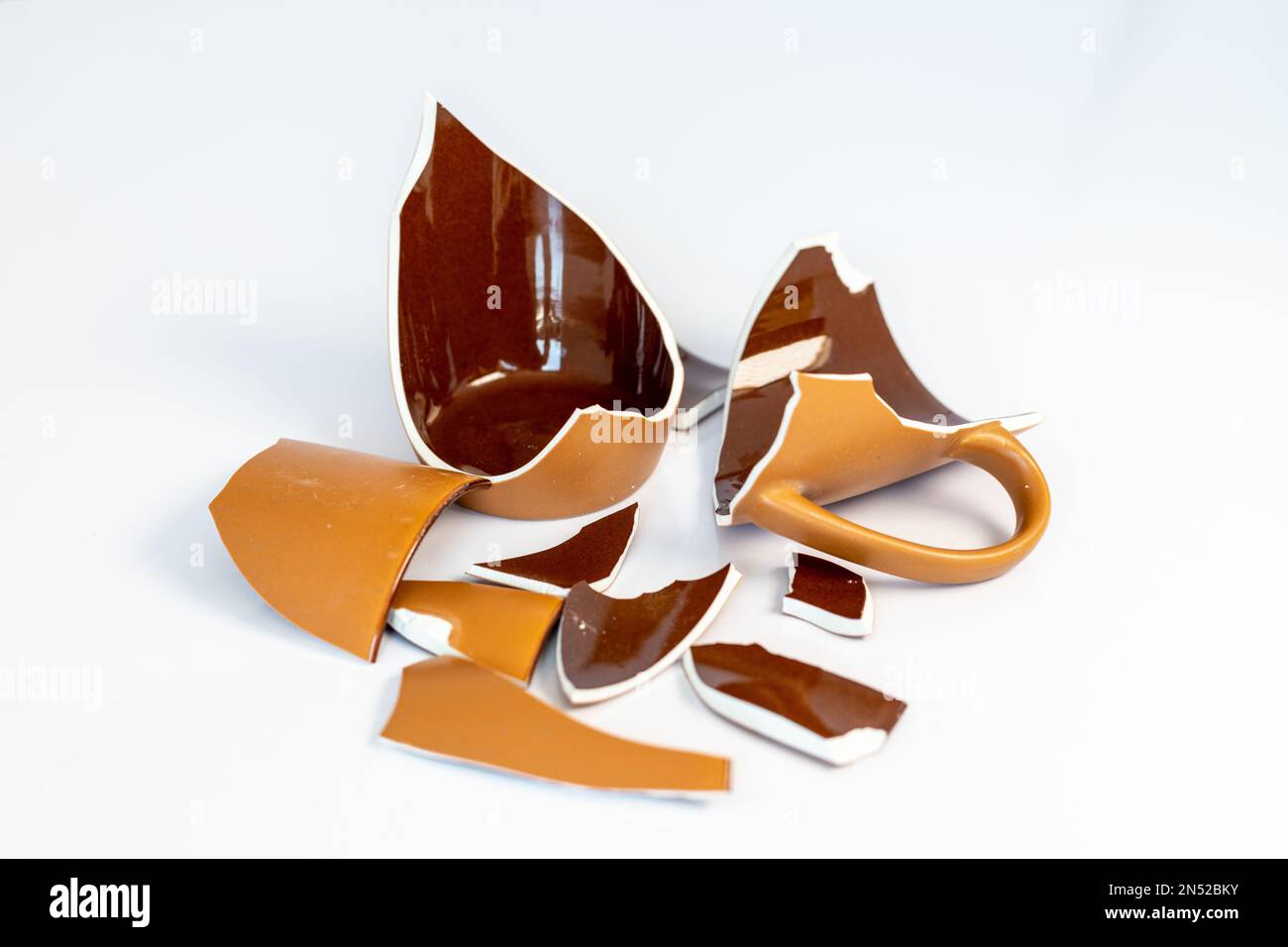 Broken tea cup isolated on white background Stock Photo - Alamy