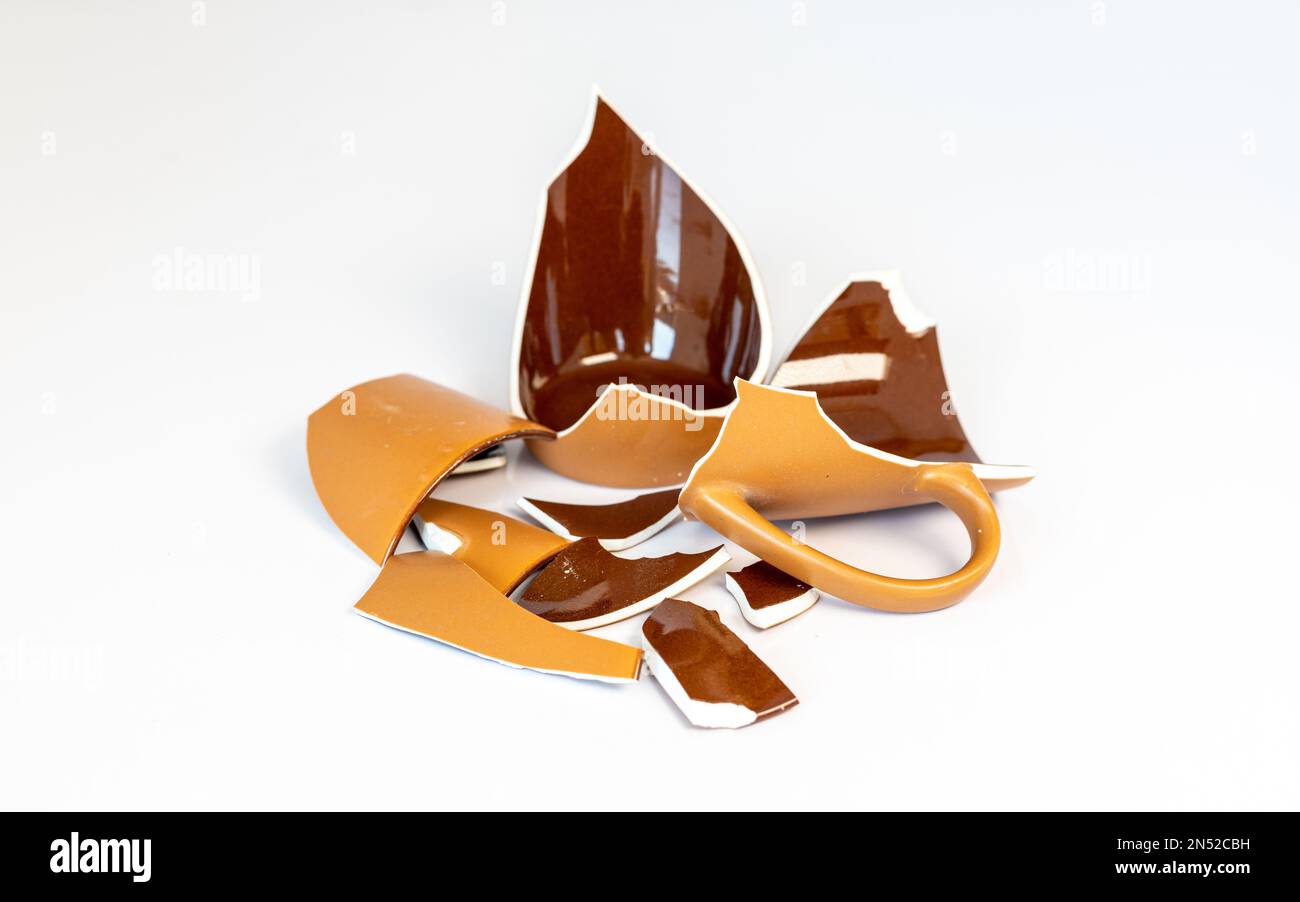 Broken earthenware pieces isolated on white background Stock Photo - Alamy