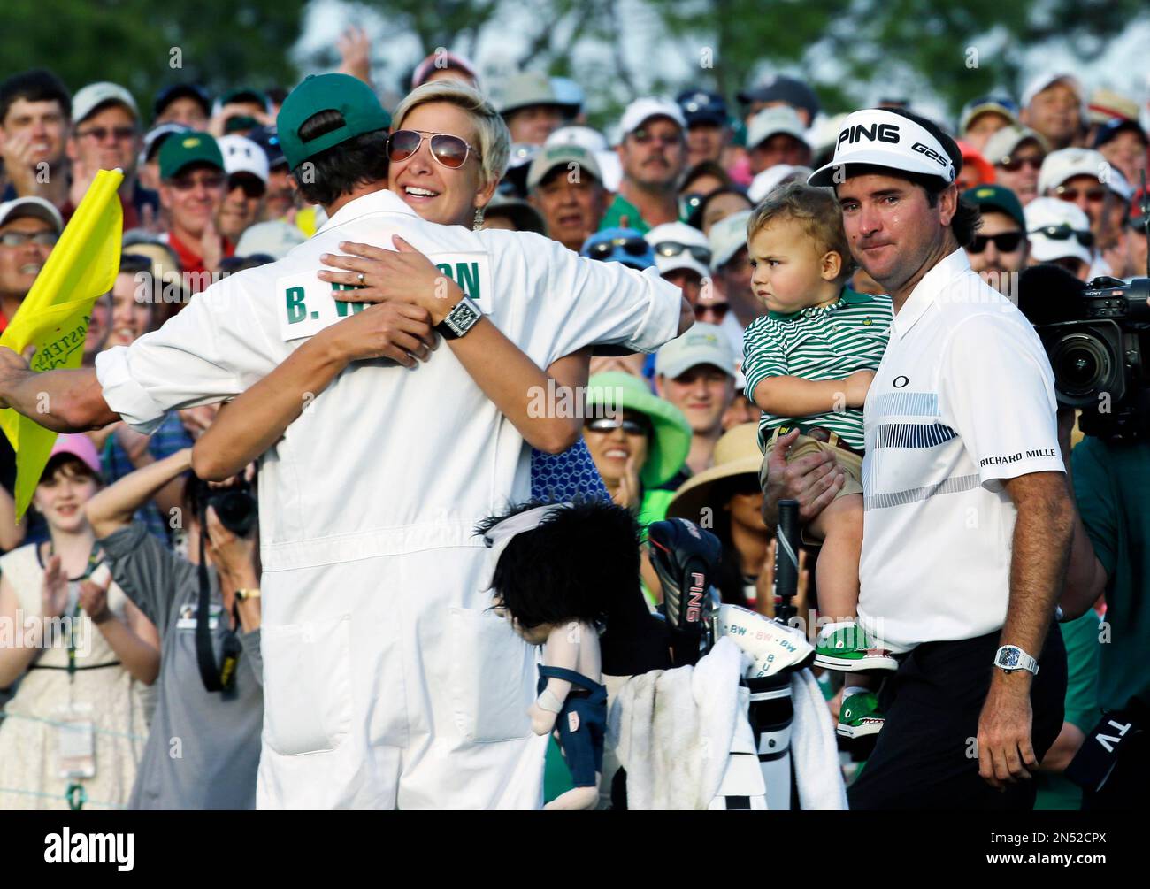 Bubba Watson's wife Angie hugs his caddie Ted Scott while Bubba Watson ...