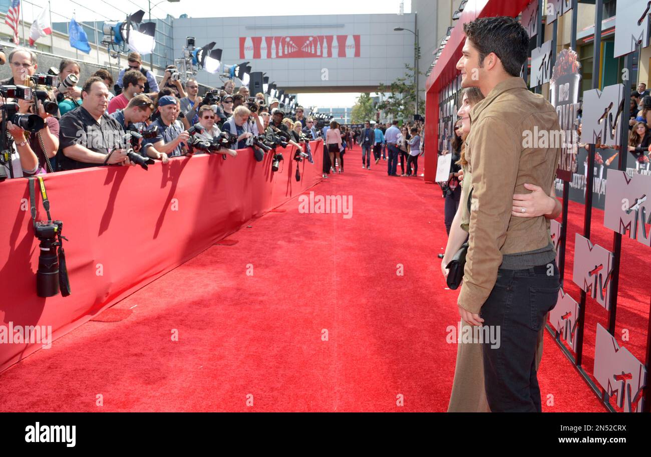 Seana Gorlick, left, and Tyler Posey arrive at the 2014 MTV Movie ...