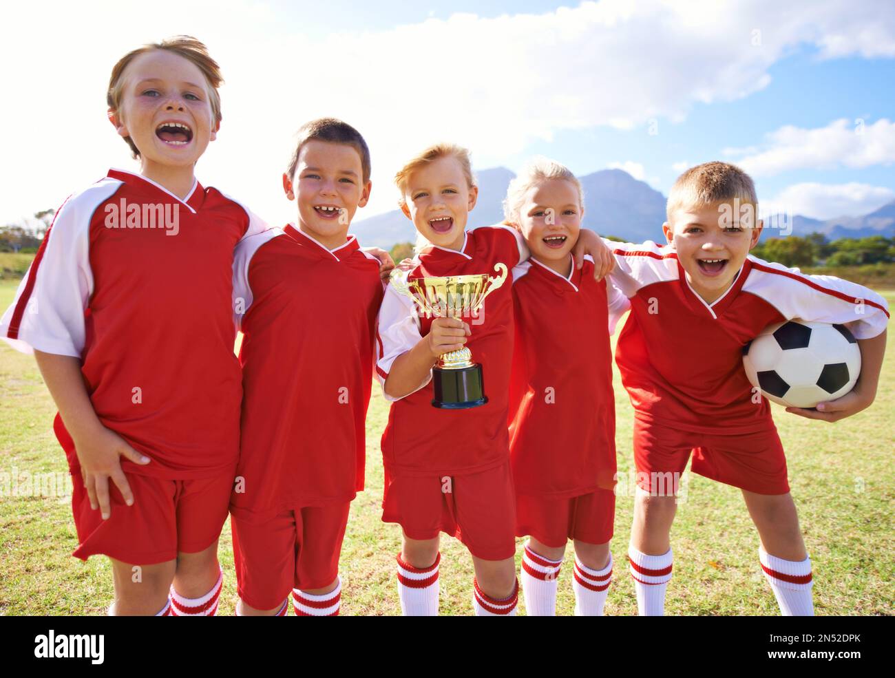 Winners of the tournament. a childrens soccer team holding a trophy ...