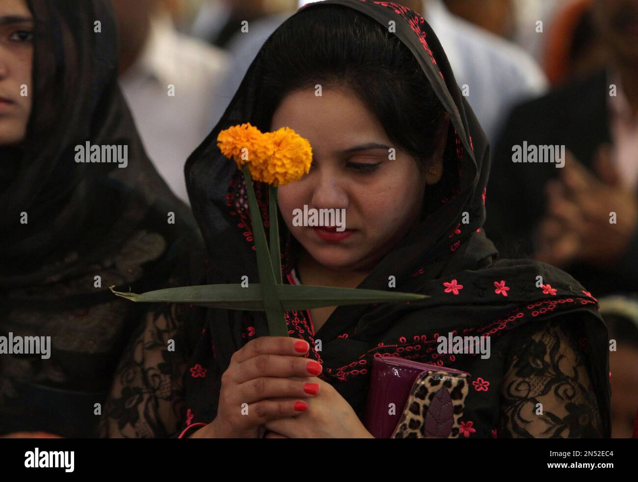 A Pakistani Christian woman prays as she attends a Palm Sunday mass in ...