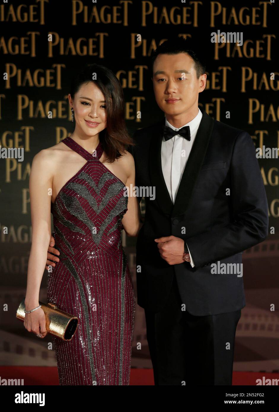 Chinese actor Tong Dawei and his wife Guan Yue pose on the red carpet of the 33rd Hong Kong Film ...