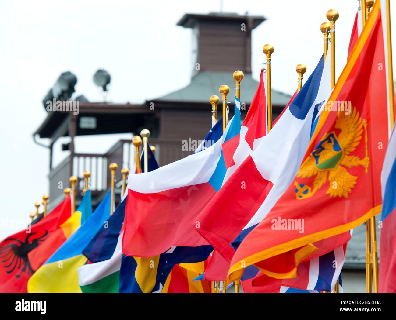 Flags of different nations wave in front of the camp entrance during ...