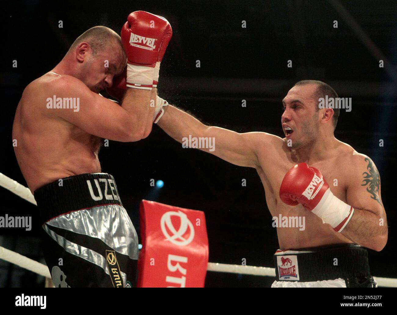 Geard Ajetovic of Serbia, right, throws a punch to IBO light ...