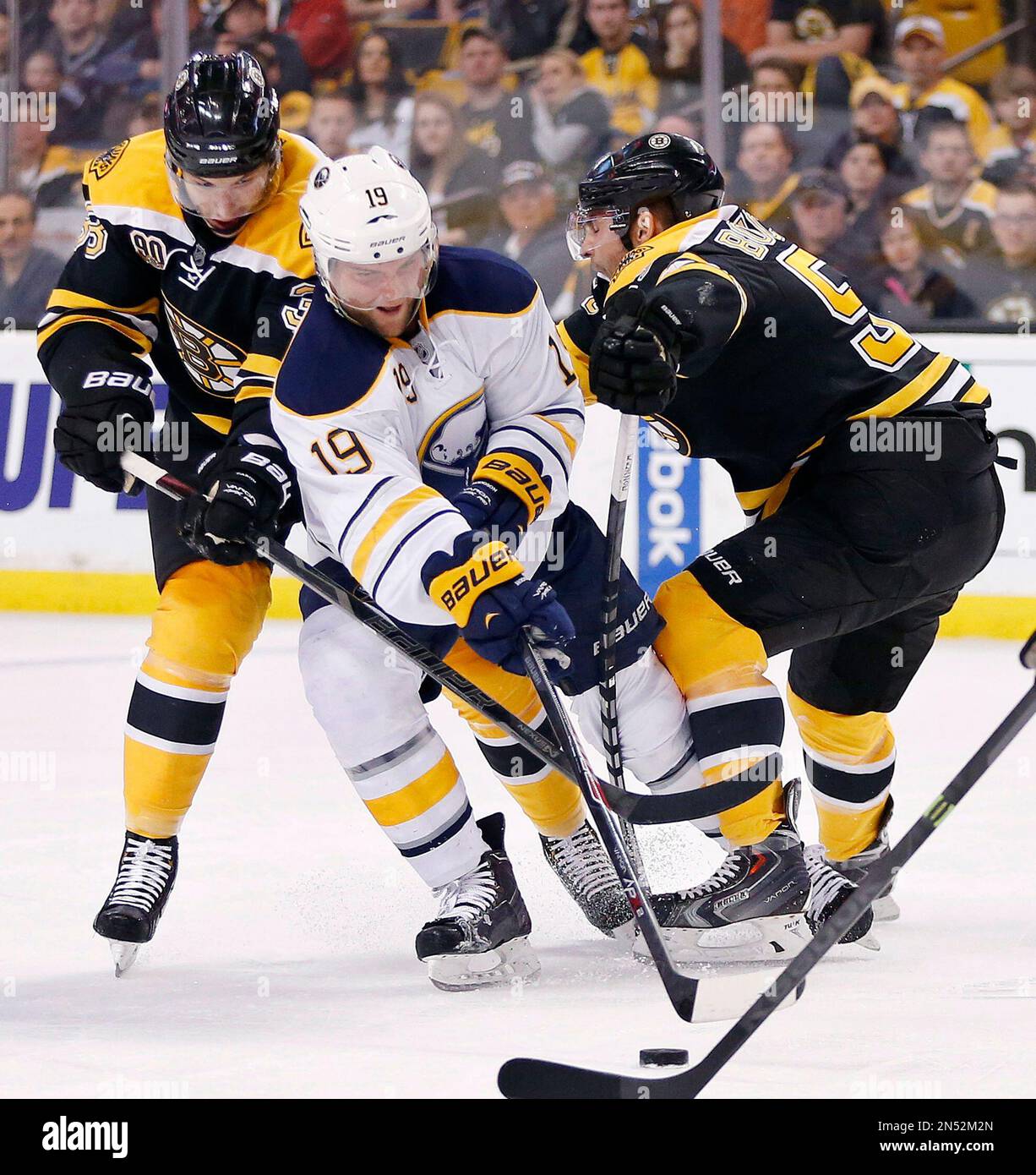 Buffalo Sabres' Cody Hodgson (19) battles Boston Bruins' Jordan Caron ...