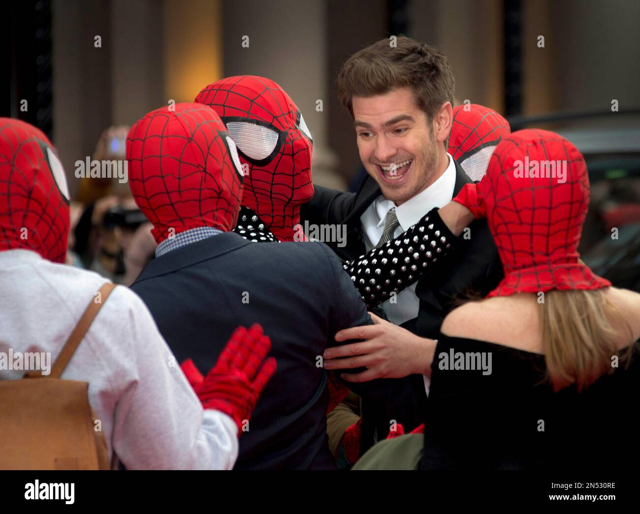 British actor Andrew Garfield, centre right, greets people wearing ...
